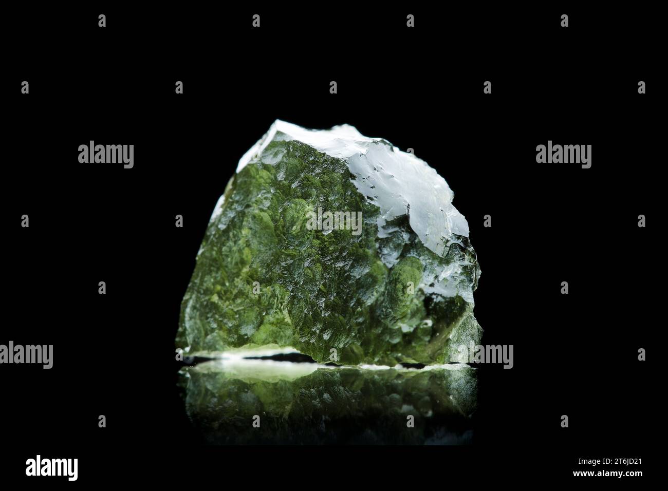 Moldavite stone isolated on black background. Close up of a green ...