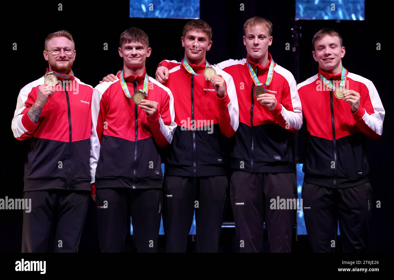 Team Denmark pose with their bronze medals on the podium following the ...