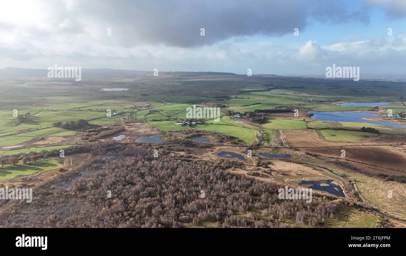 An aerial view of a rural countryside under a bright sky in New Cumnock ...