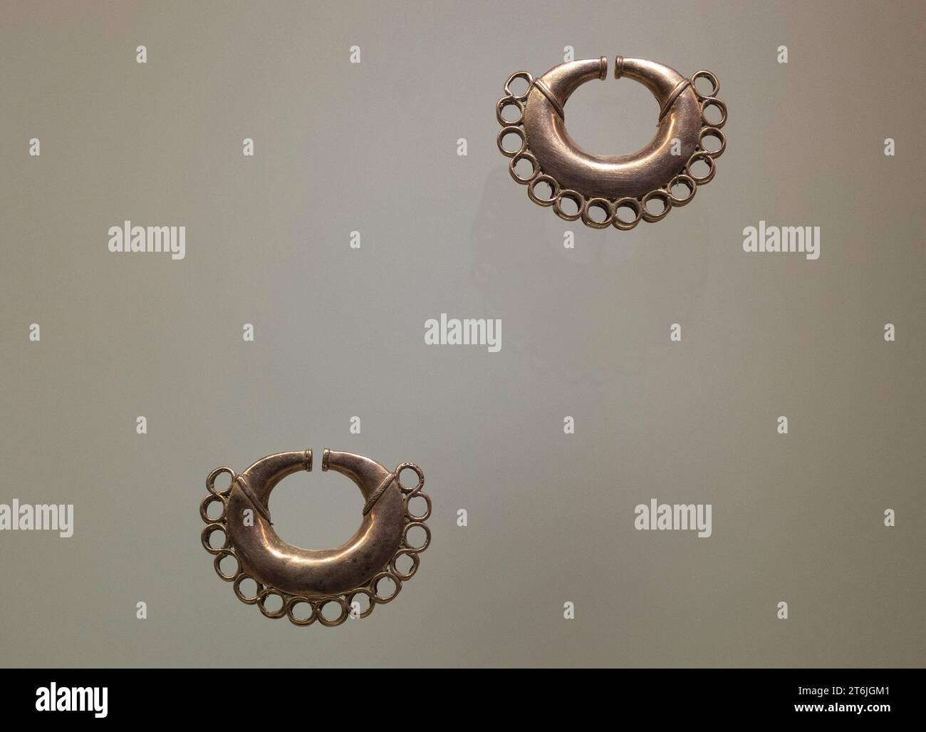 Close up to a two beautiful ancient golden nose rings at golden museum ...
