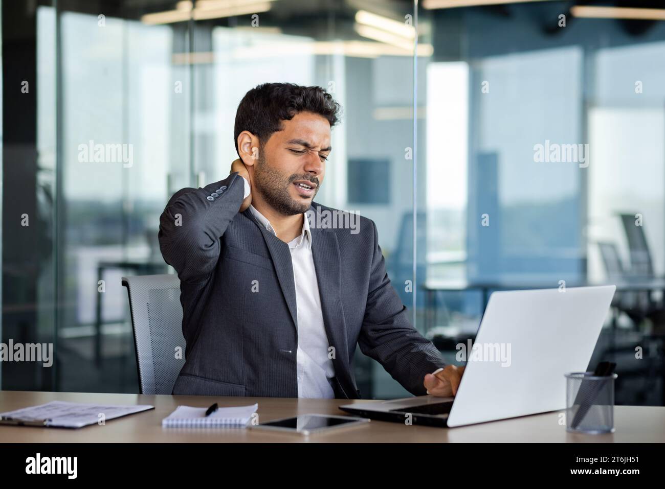 Neck pain, overworked and overtired man working late, businessman ...