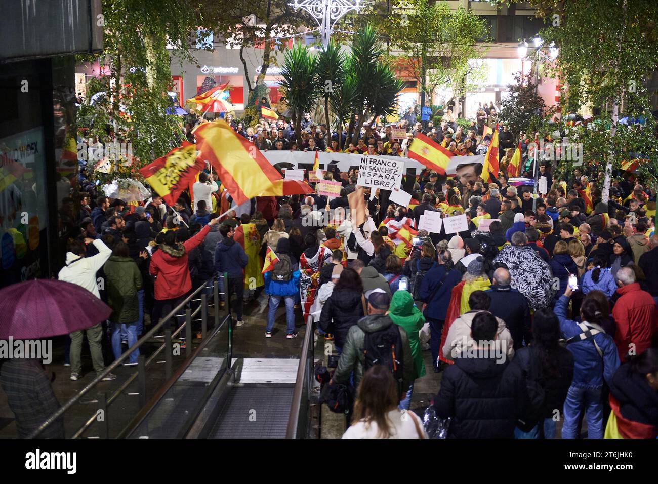 Hundreds of people carry flags and posters, during a rally against ...