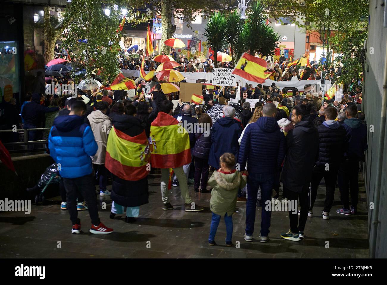Hundreds of people carry flags and posters, during a rally against ...