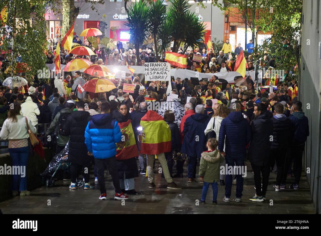 Hundreds of people carry flags and posters, during a rally against ...