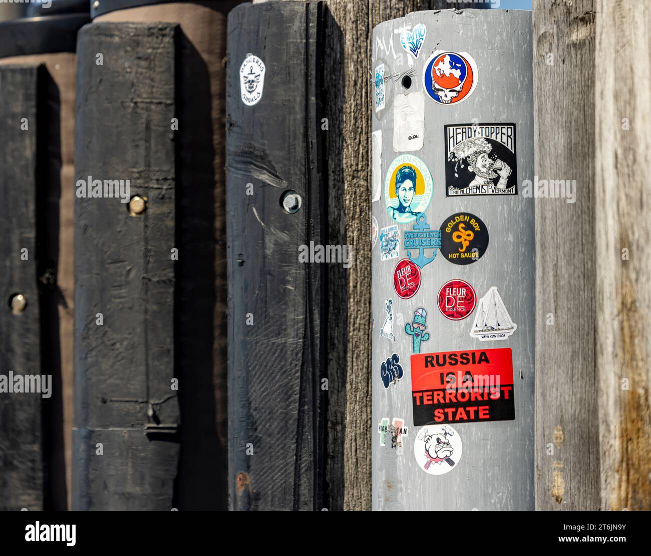 random stickers on a piling Stock Photo - Alamy