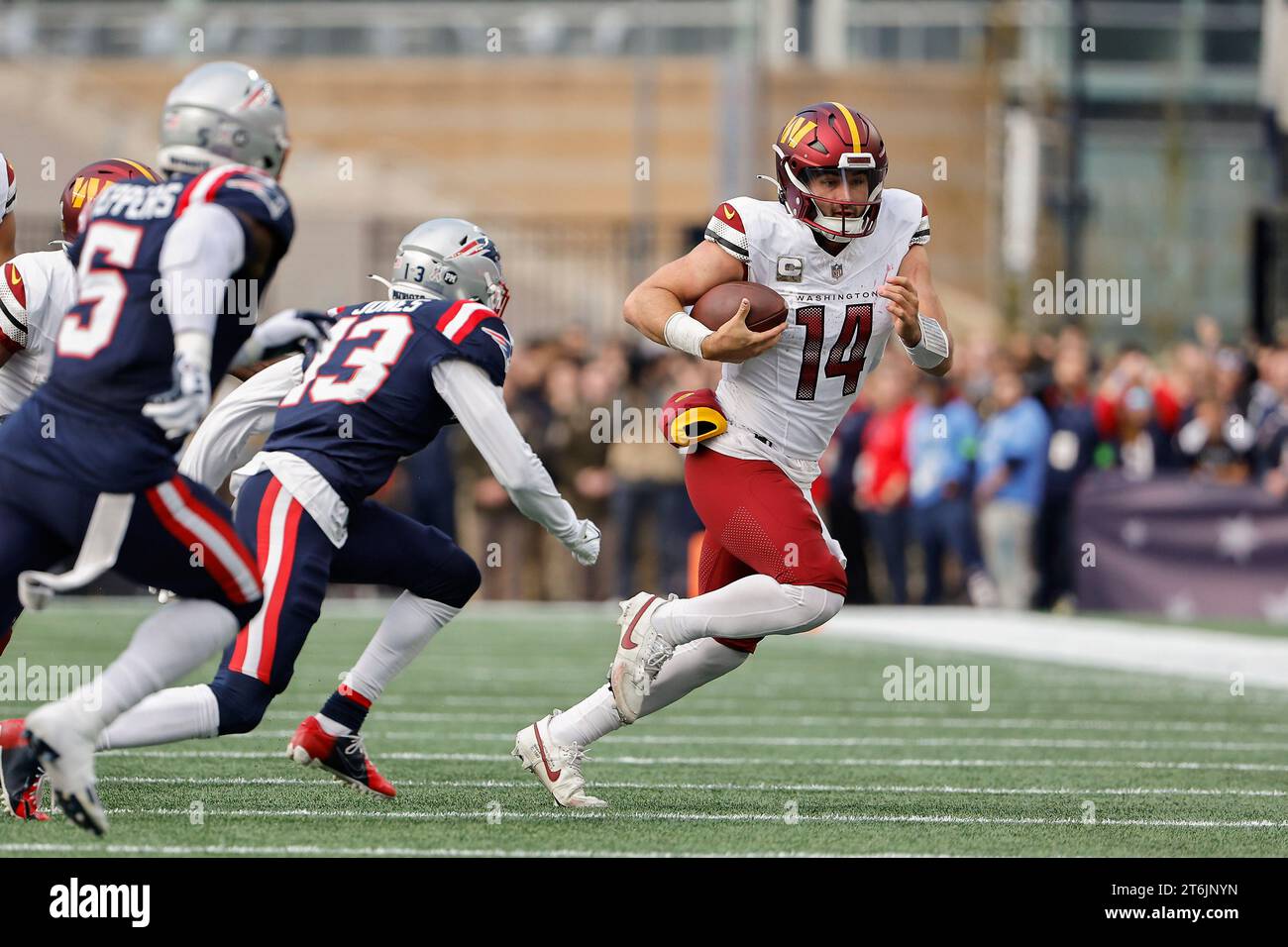 Washington Commanders quarterback Sam Howell runs against the New ...