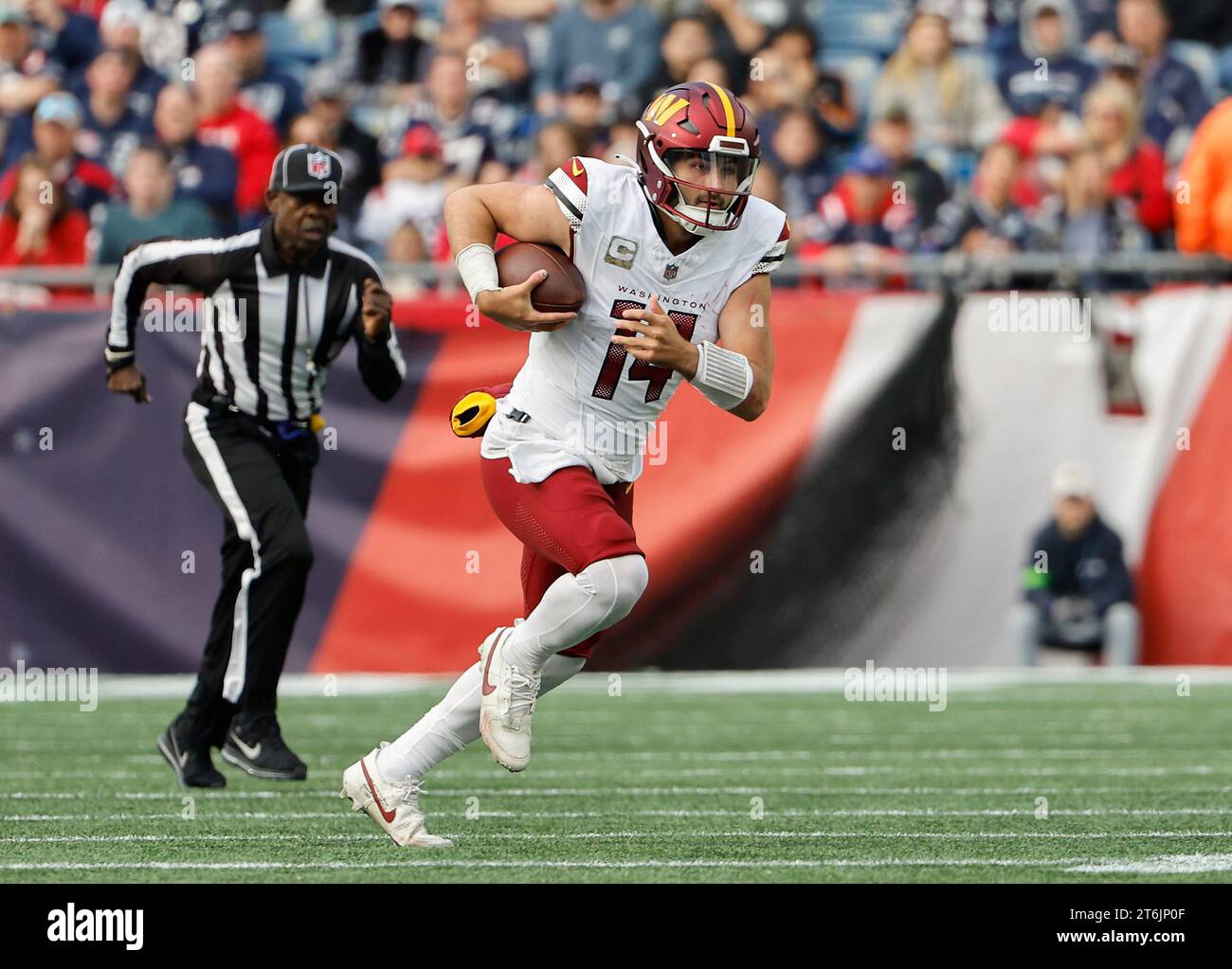 Washington Commanders quarterback Sam Howell runs against the New ...
