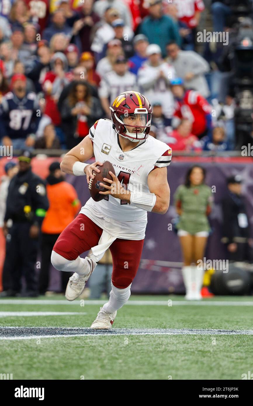 Washington Commanders quarterback Sam Howell scrambles against the New England Patriots during ...