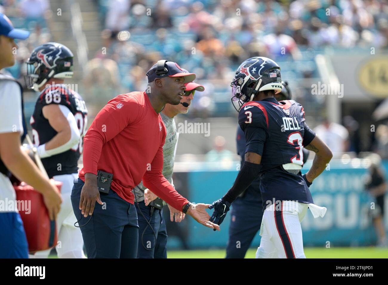 Houston Texans head coach DeMeco Ryans, left, greets wide receiver Tank Dell (3) on the sideline ...