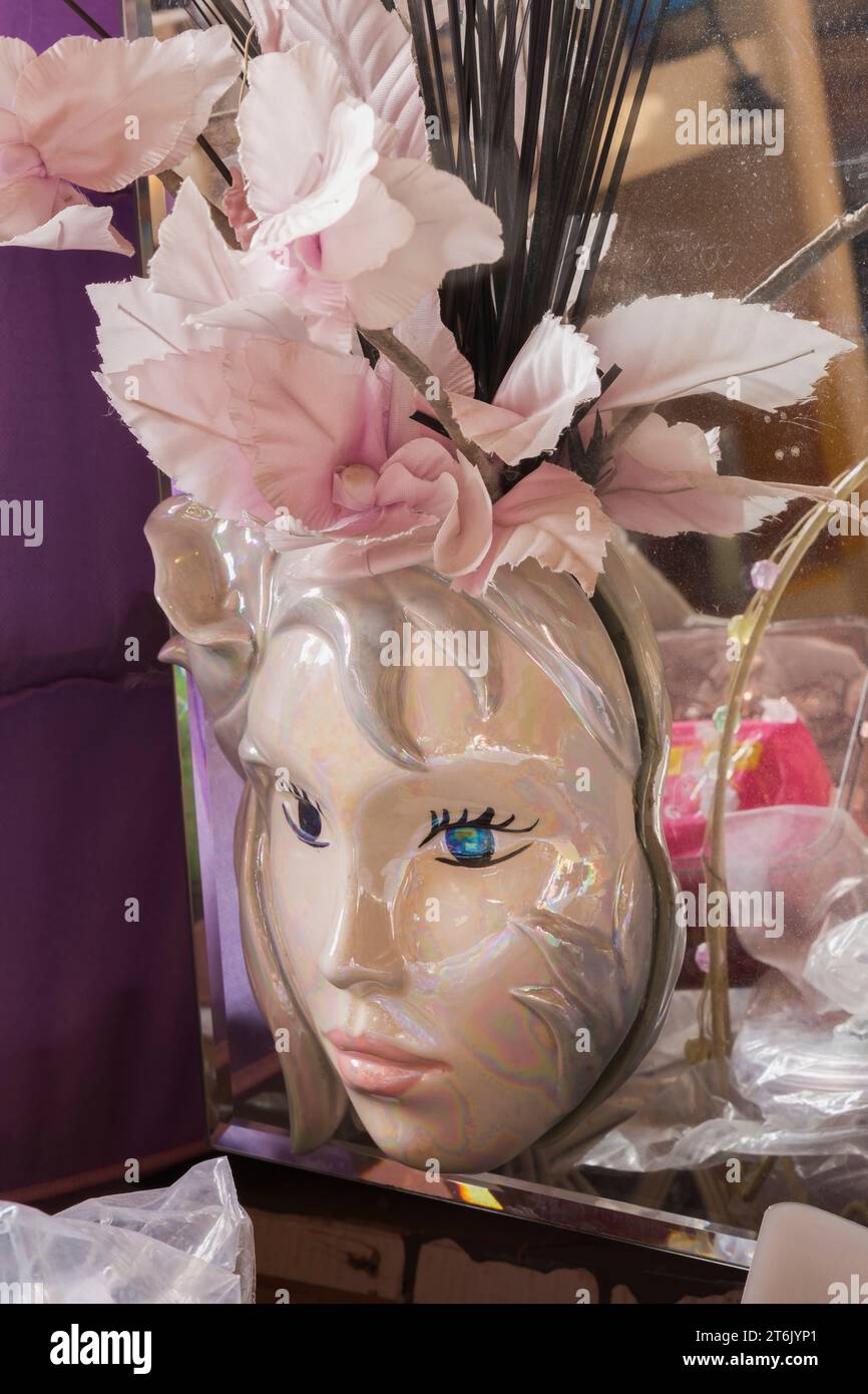 Decorated mannequin head and silk flowers for sale inside second hand ...