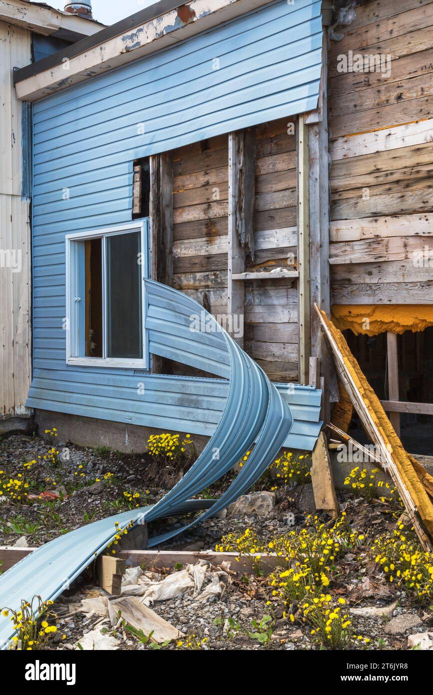 Partially demolished blue vinyl cladded building Stock Photo - Alamy