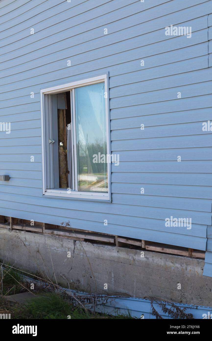Partially demolished blue vinyl cladded building Stock Photo - Alamy