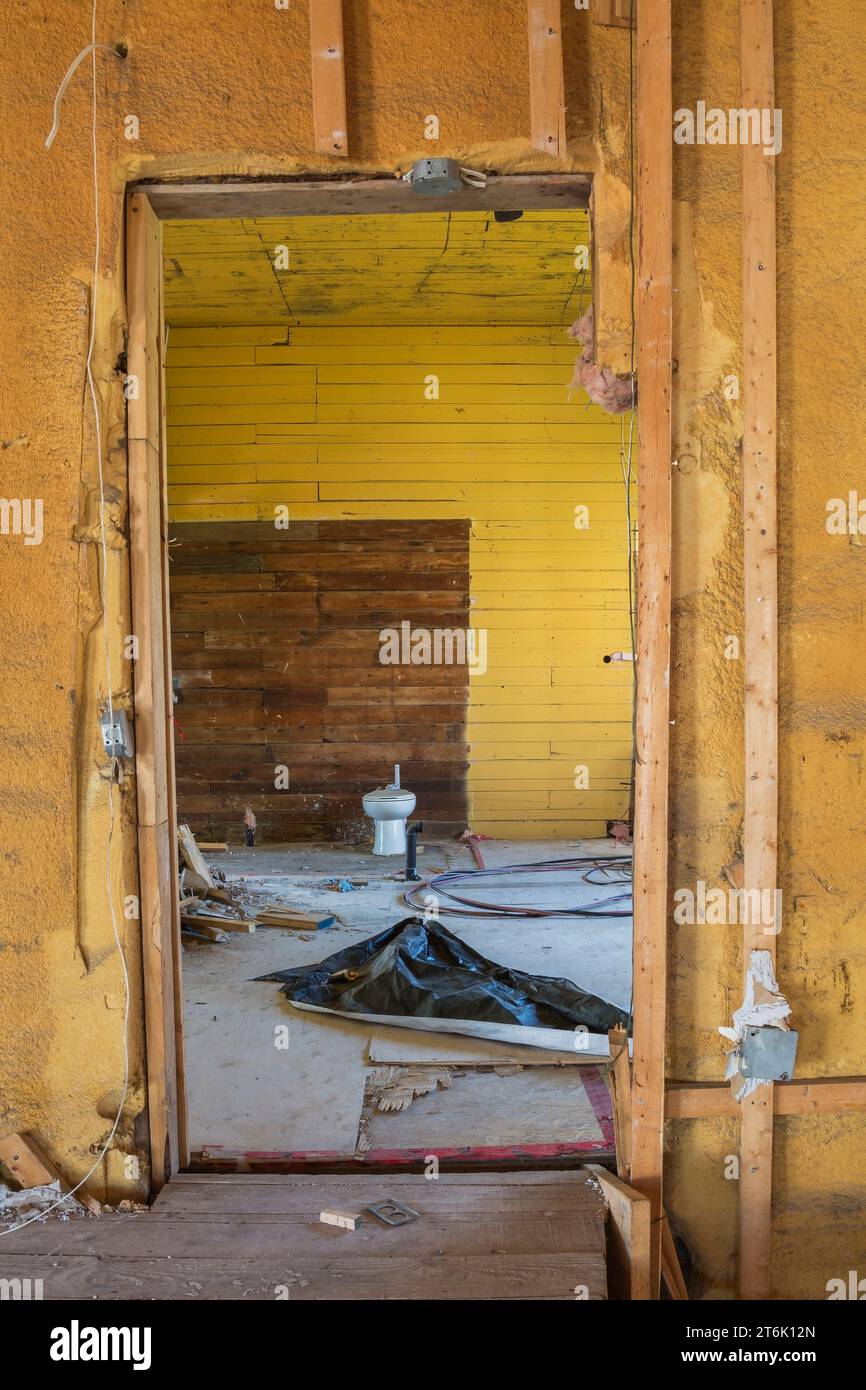 Old toilet with water tank removed and debris in abandoned commercial ...
