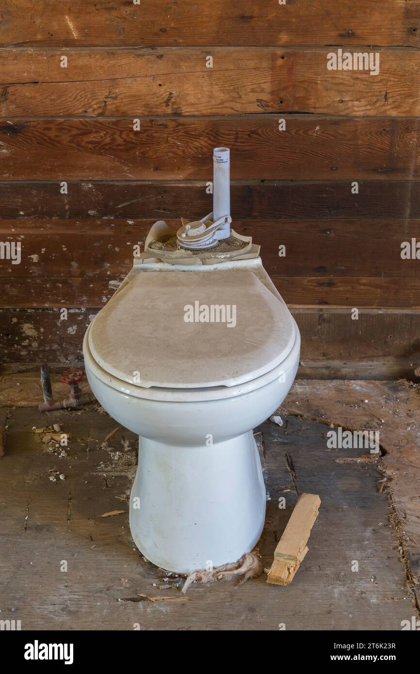 Old toilet with water tank removed in abandoned commercial building ...