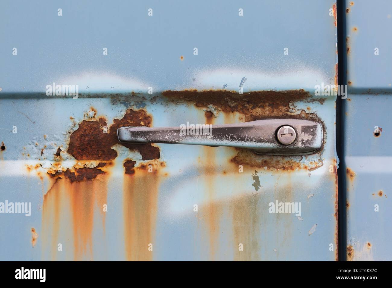 Rust spots and handle with keyhole on door of old blue truck Stock ...
