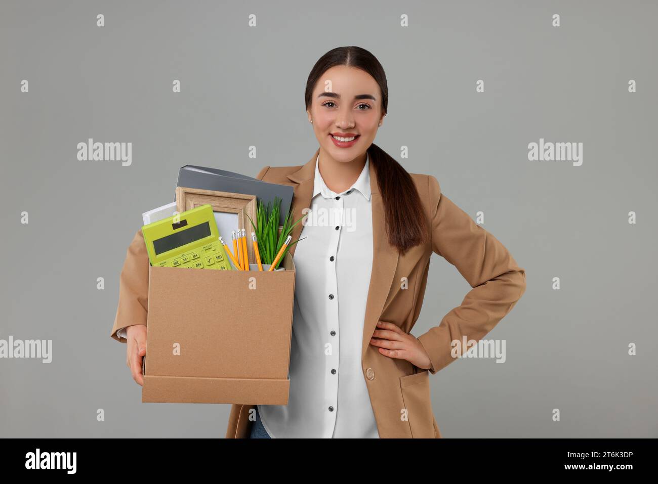Happy unemployed woman holding box with personal office belongings on ...