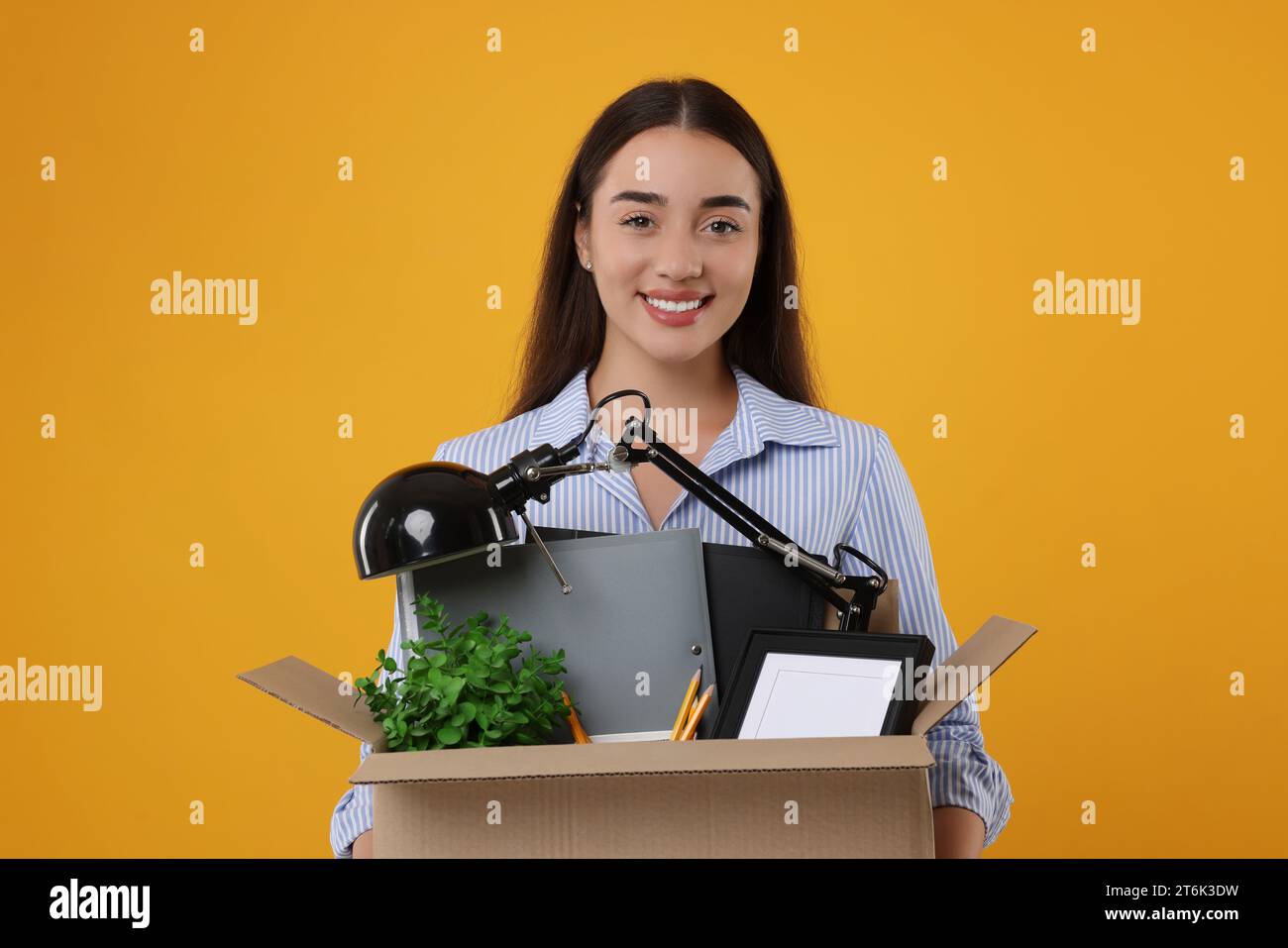 Happy unemployed woman holding box with personal office belongings on ...