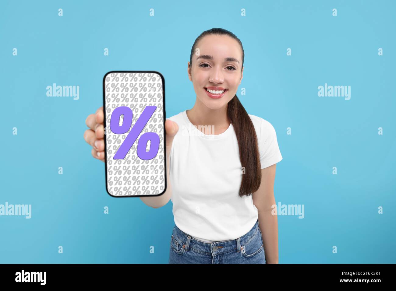 Discount, offer, sale. Woman showing mobile phone with percent signs on ...