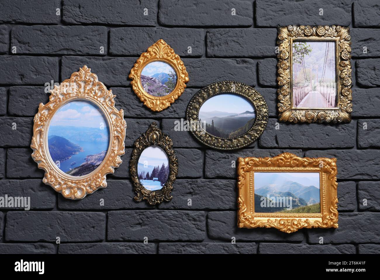 Vintage frames with photos of beautiful landscapes hanging on dark ...