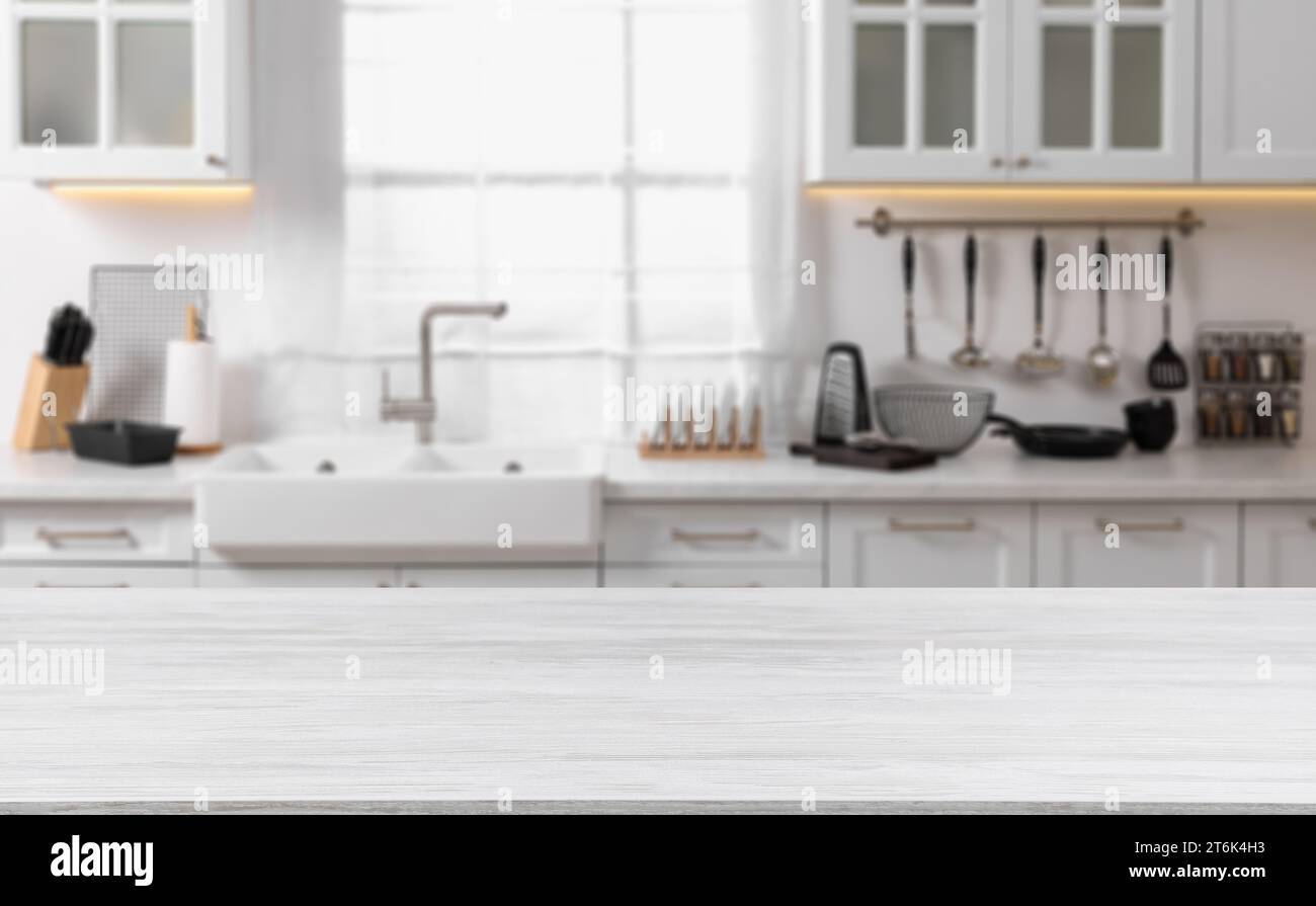 Empty wooden table in beautiful kitchen. Space for design Stock Photo ...