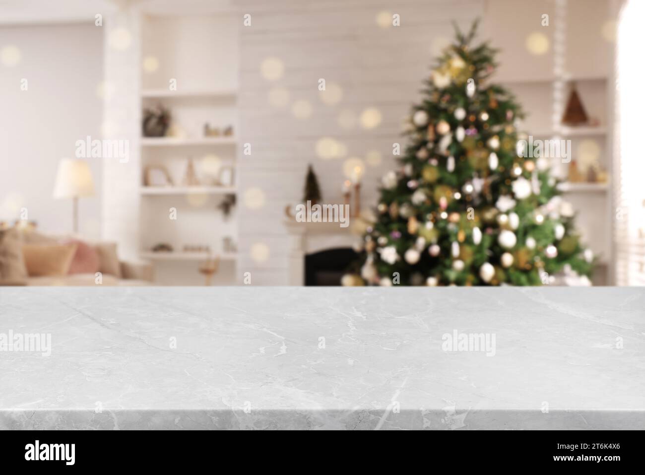 Light grey marble table in room with Christmas tree. Space for design ...