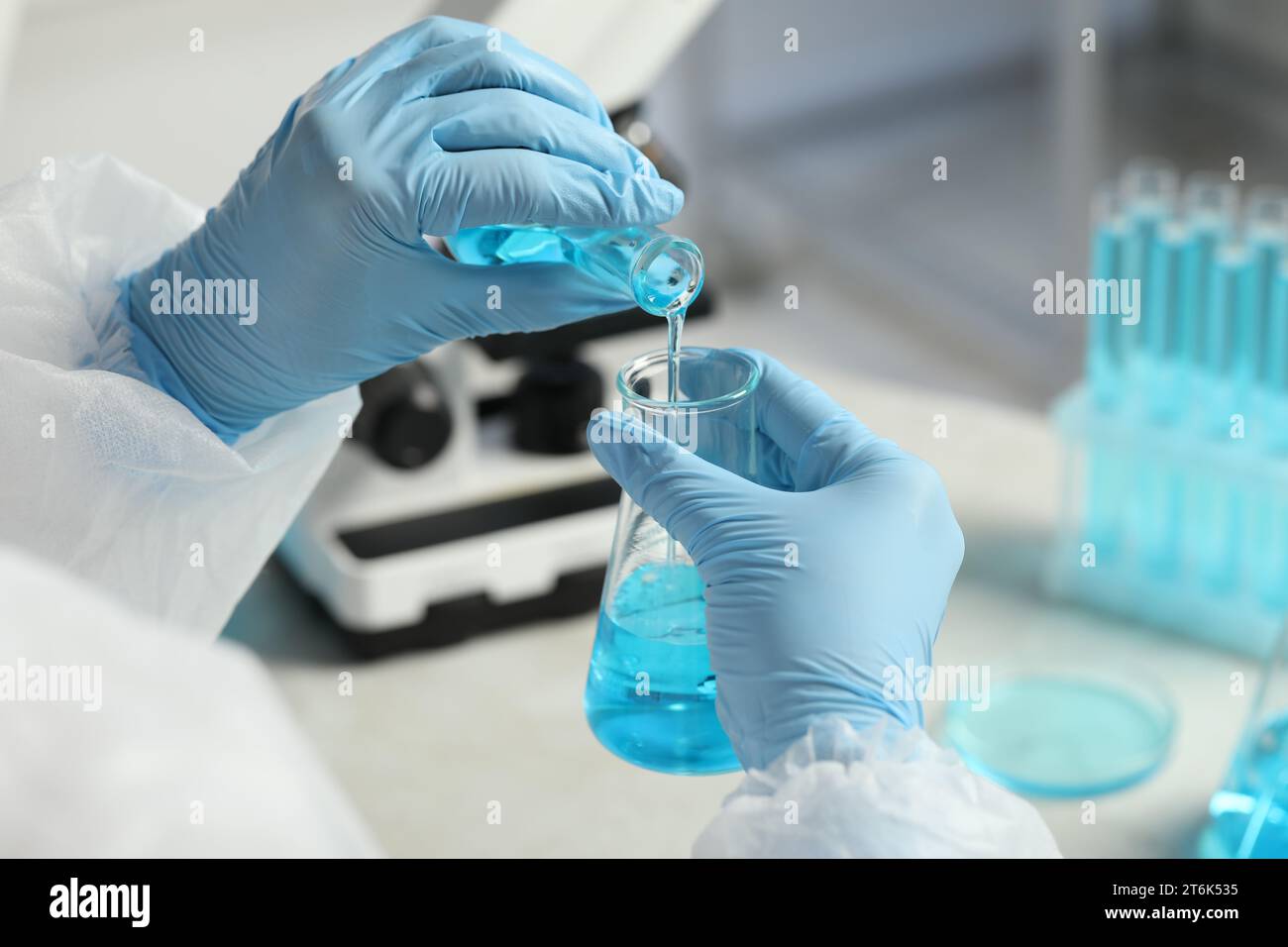 Female scientist microscope flasks hi-res stock photography and images ...