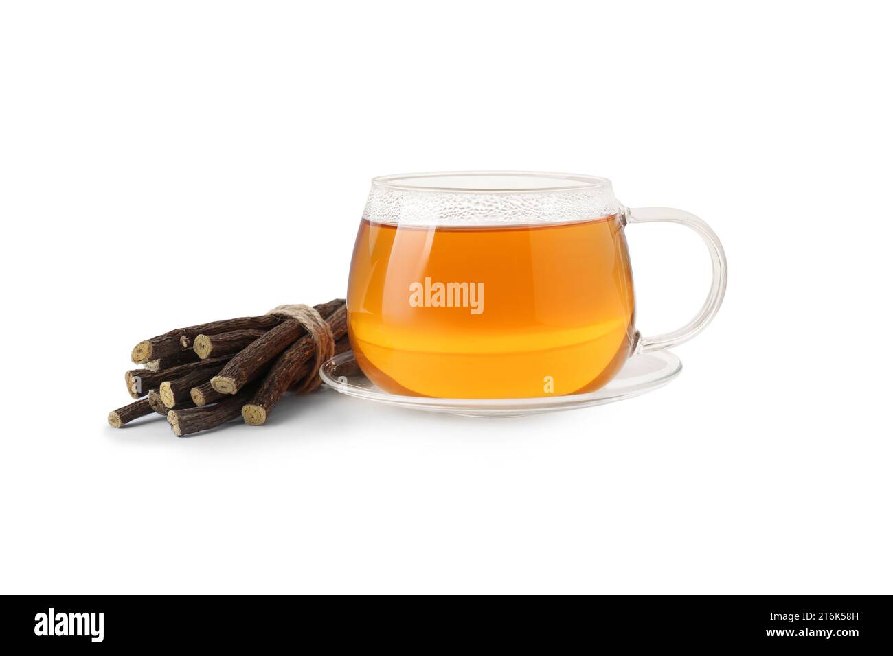 Aromatic licorice tea in cup and dried sticks of licorice root isolated ...