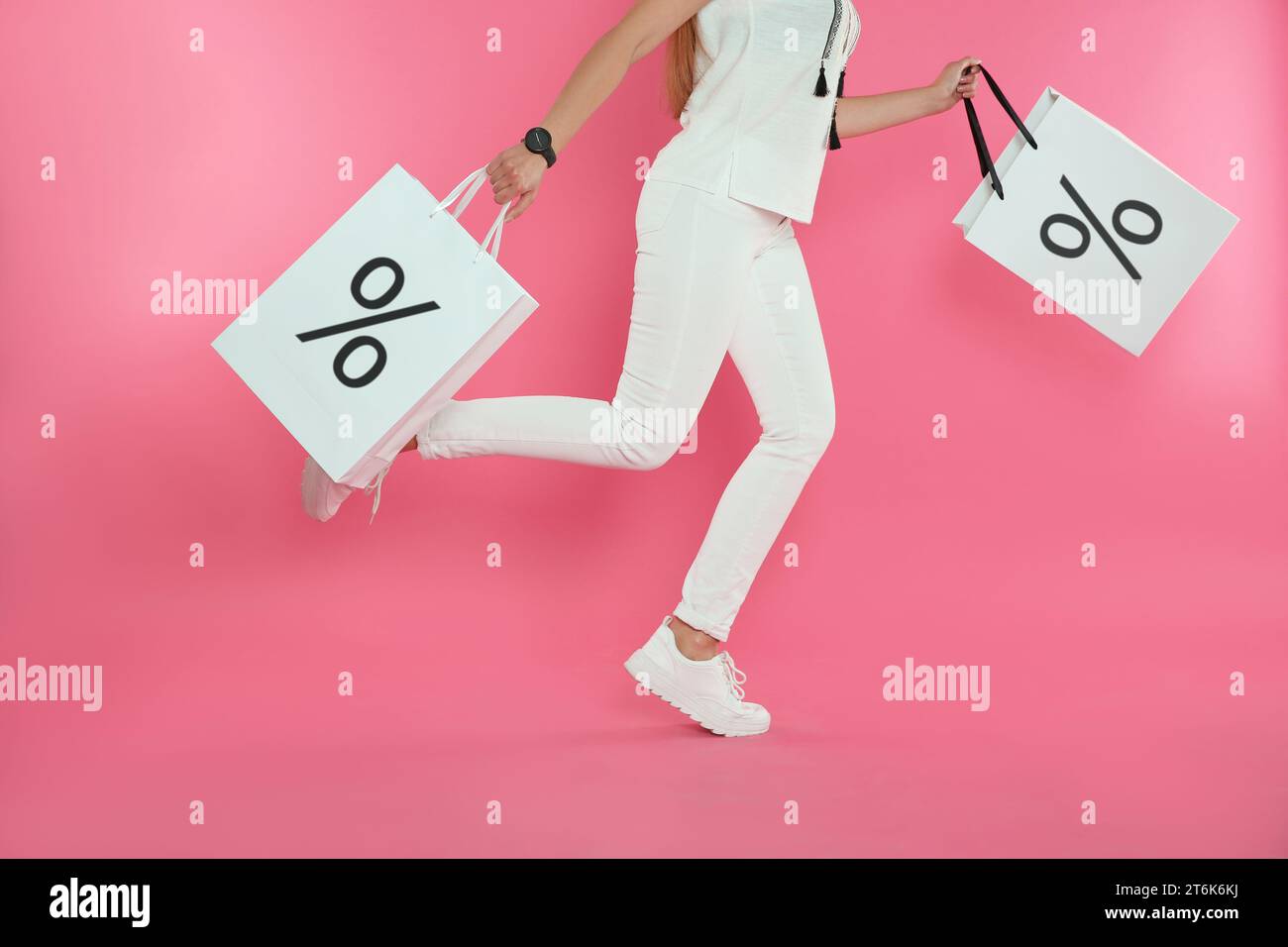Discount, sale, offer. Woman running with shopping bags against pink ...