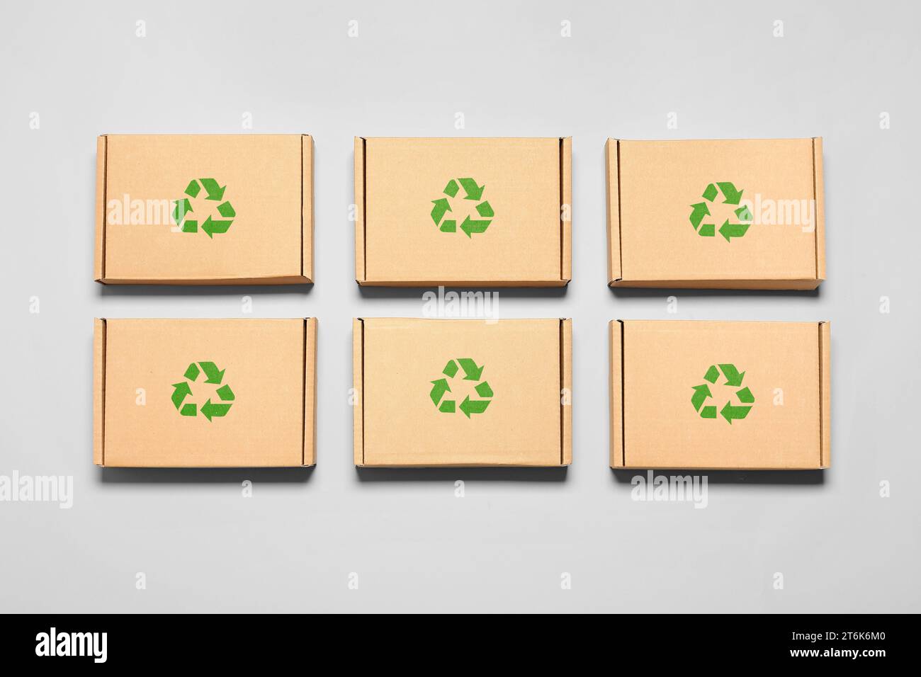 Cardboard boxes with recycle sign stamps on light grey background, flat ...