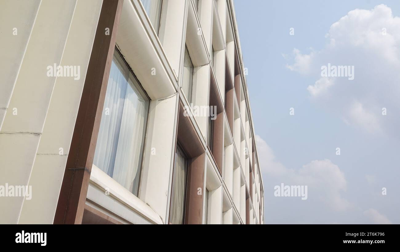 tall white building full of windows with a brown palette Stock Photo ...