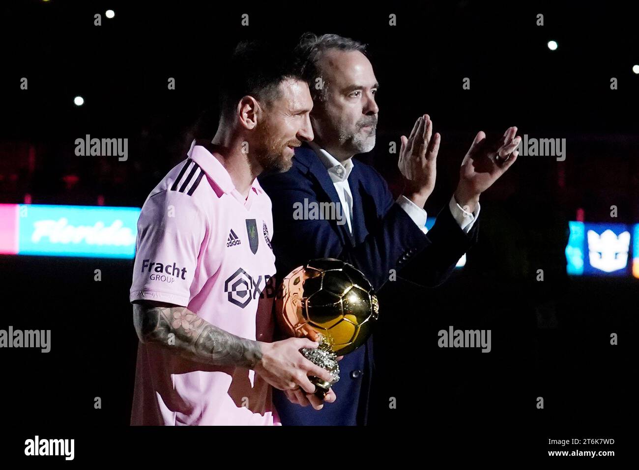 Inter Miami forward Lionel Messi, left, walks off the field with his ...