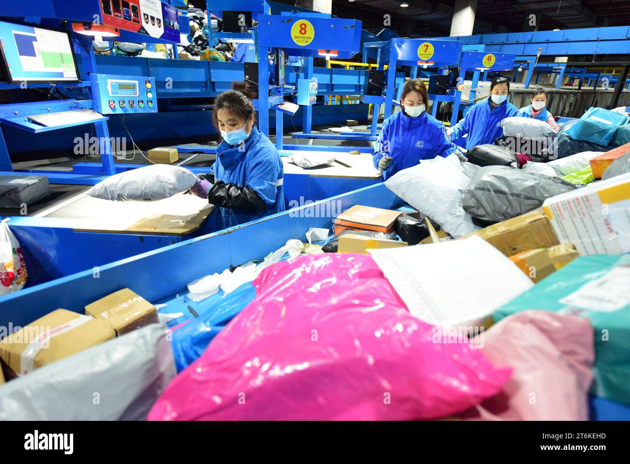 LIANYUNGANG, CHINA - NOVEMBER 11, 2023 - Workers sort parcels on an ...