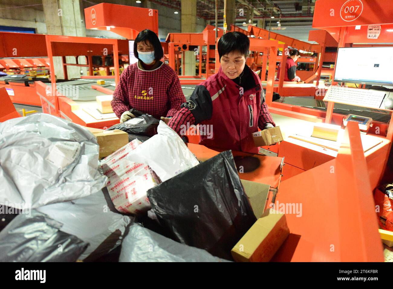 LIANYUNGANG, CHINA - NOVEMBER 11, 2023 - Workers sort parcels on an ...