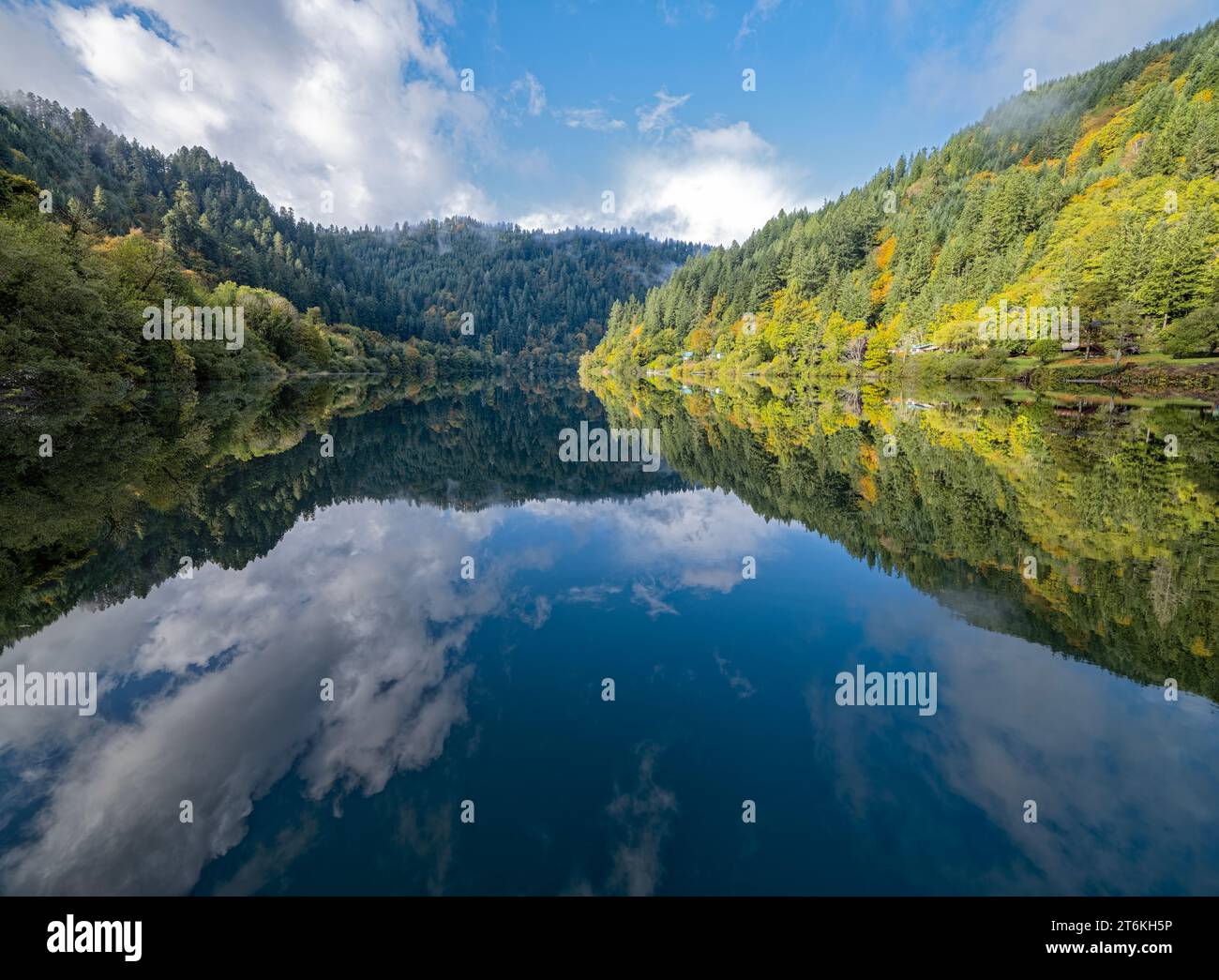 Early morning reflections in the Umpqua River at the county park ...