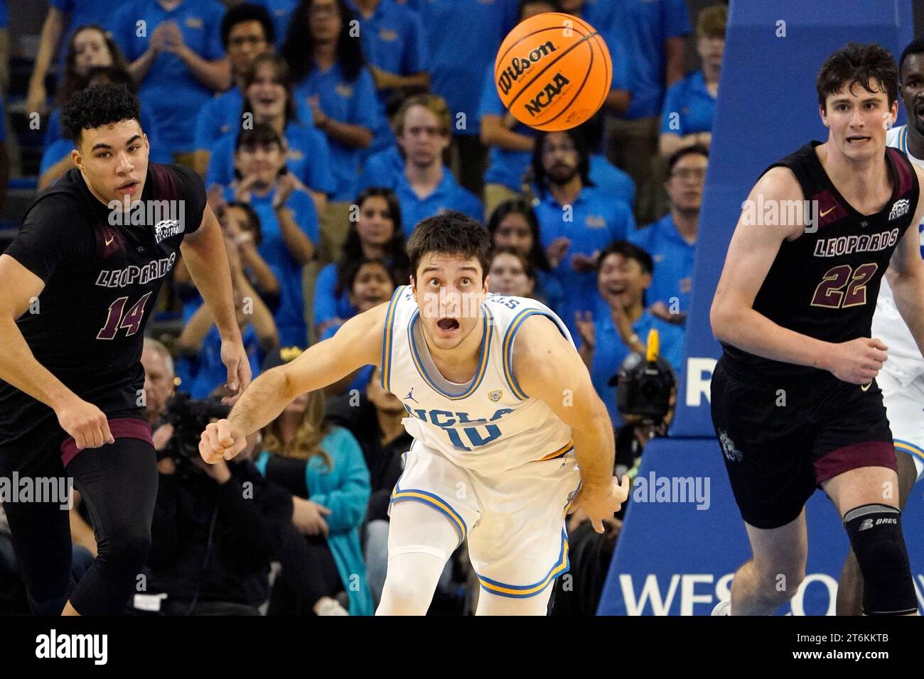 UCLA guard Lazar Stefanovic, center, chases a loose ball along with ...