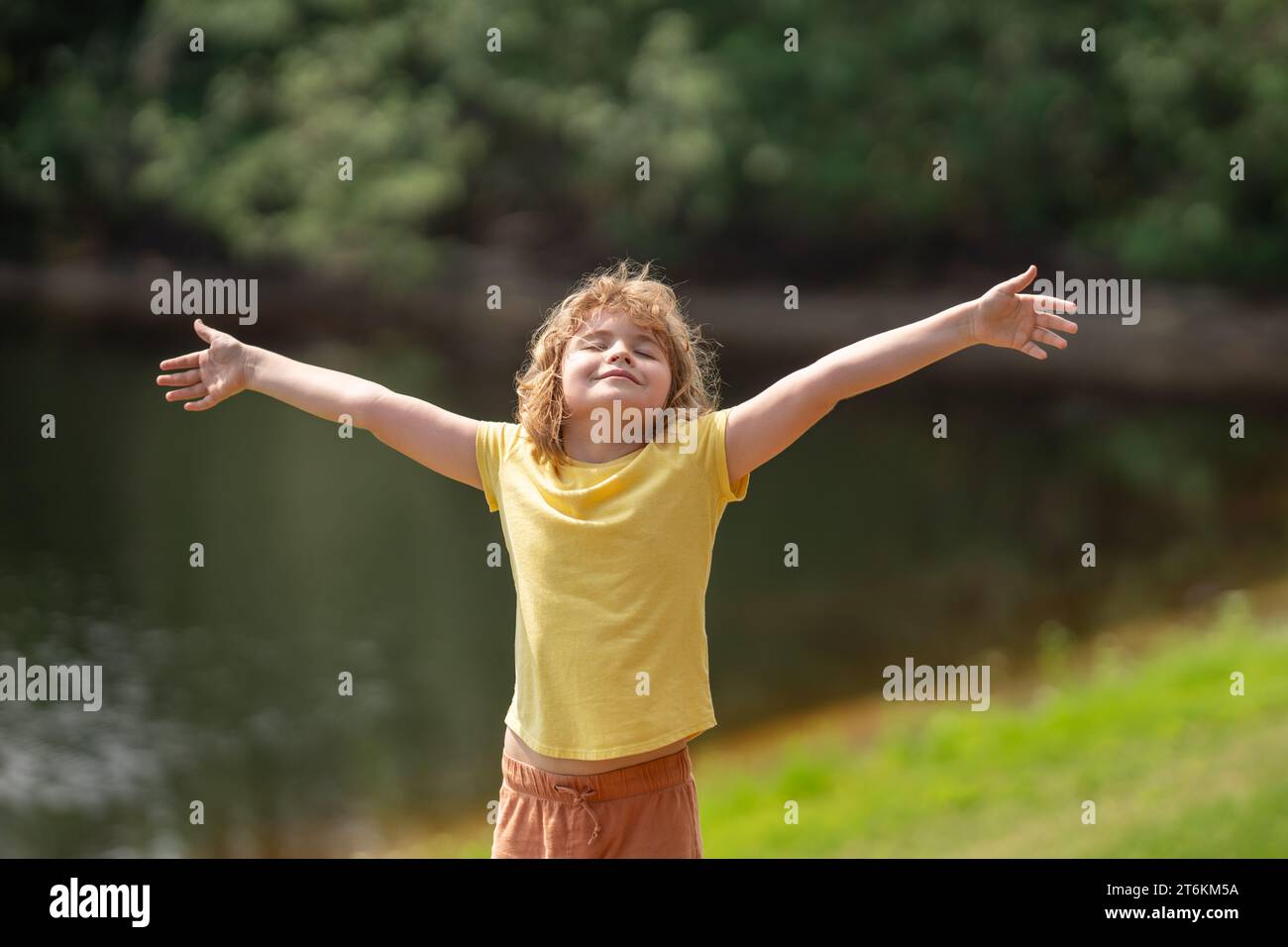 Happy child with arms up enjoying freedom in nature. Child ppen arms ...