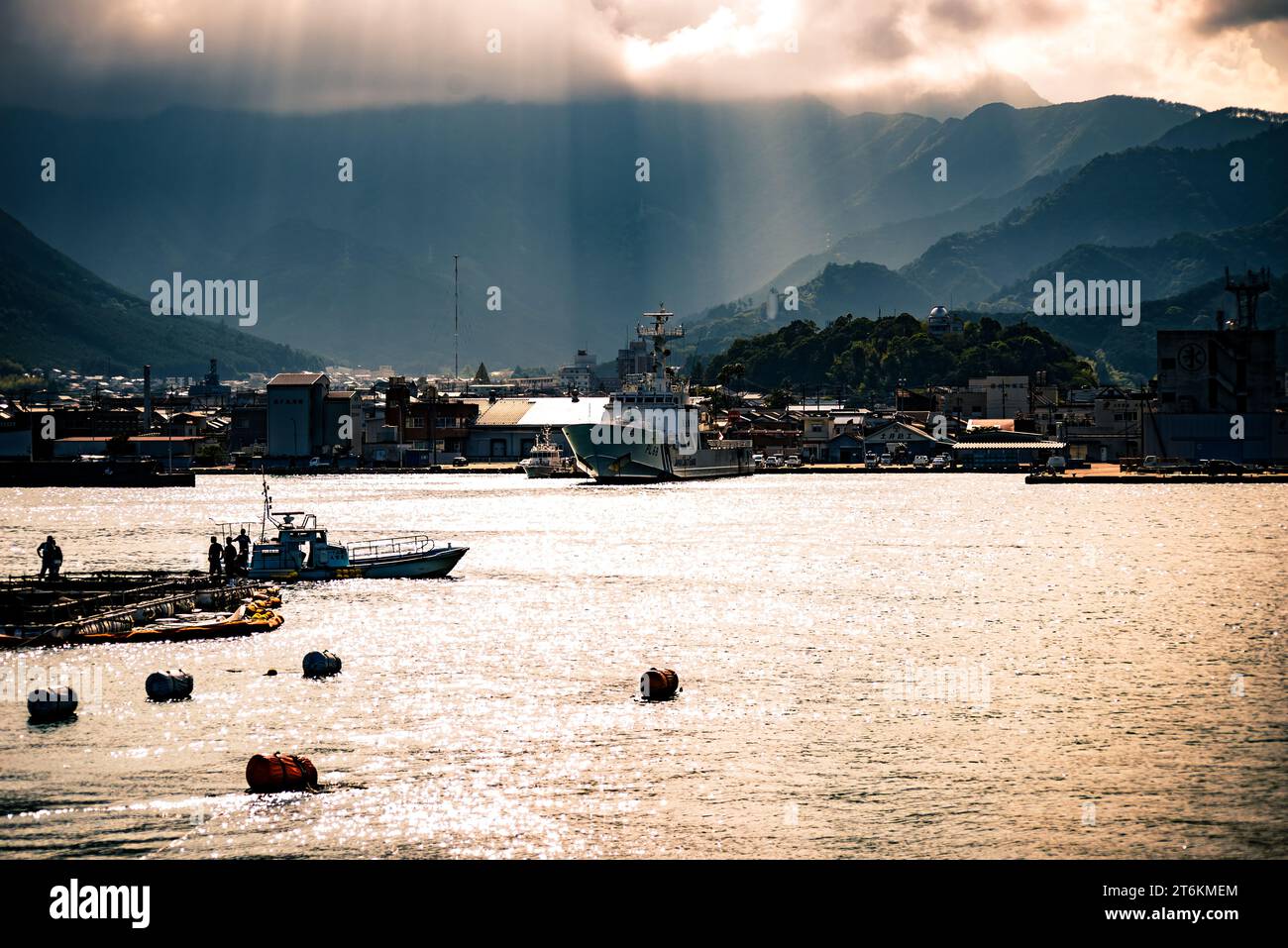 Scenery of a small port shining in the sunset Stock Photo - Alamy
