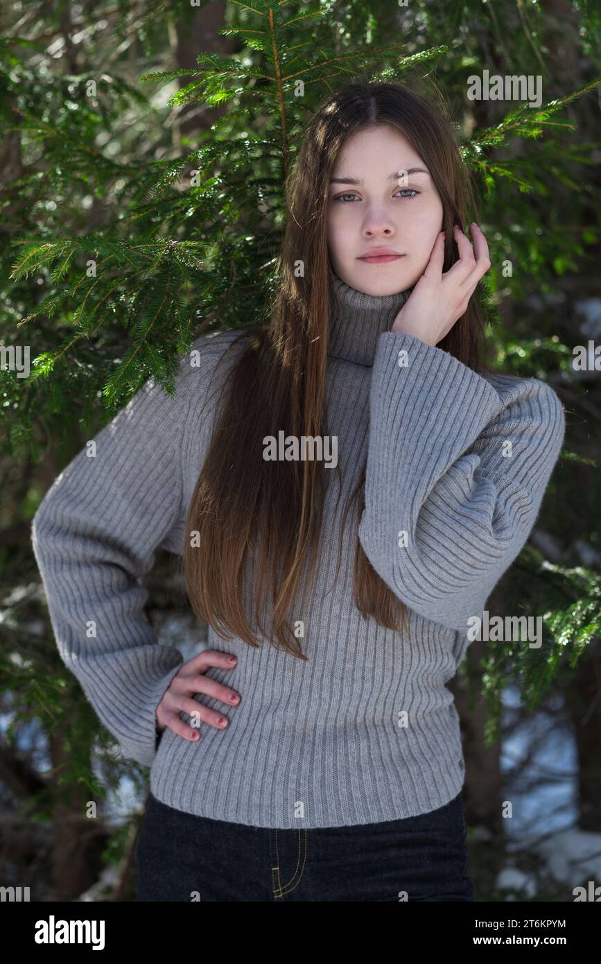 Portrait of teenage girl standing in pine forest. Brunette teenager ...