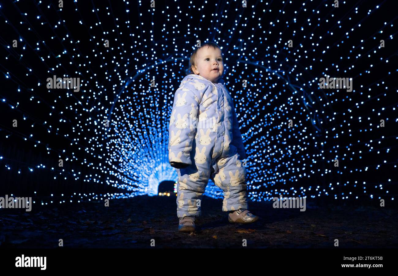 One-year-old Summer enjoys walking through a light installation during ...