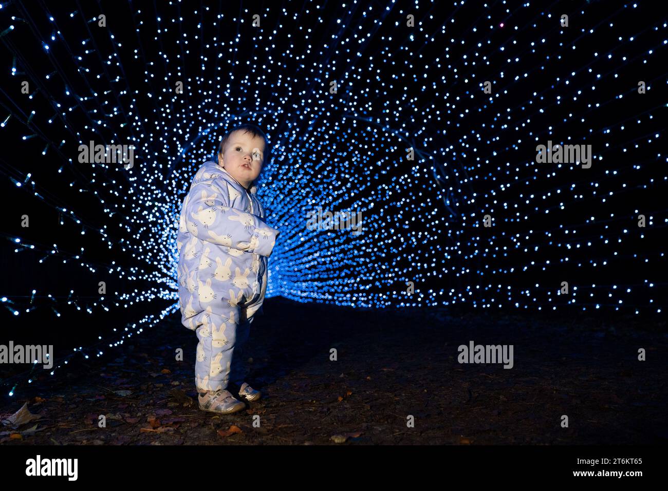 One-year-old Summer enjoys walking through a light installation during ...