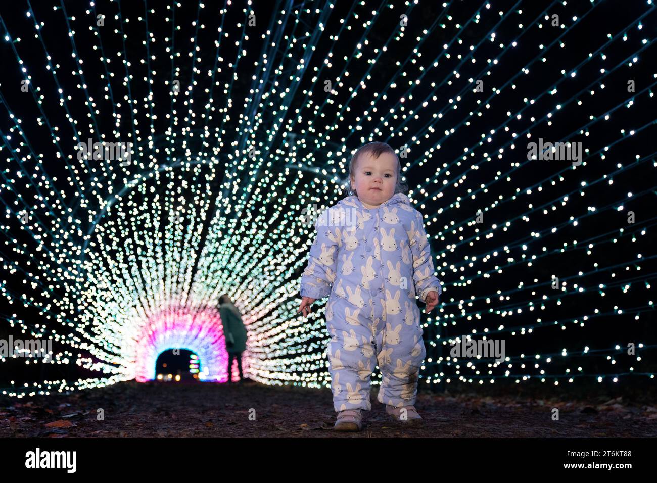 One-year-old Summer enjoys walking through a light installation during ...