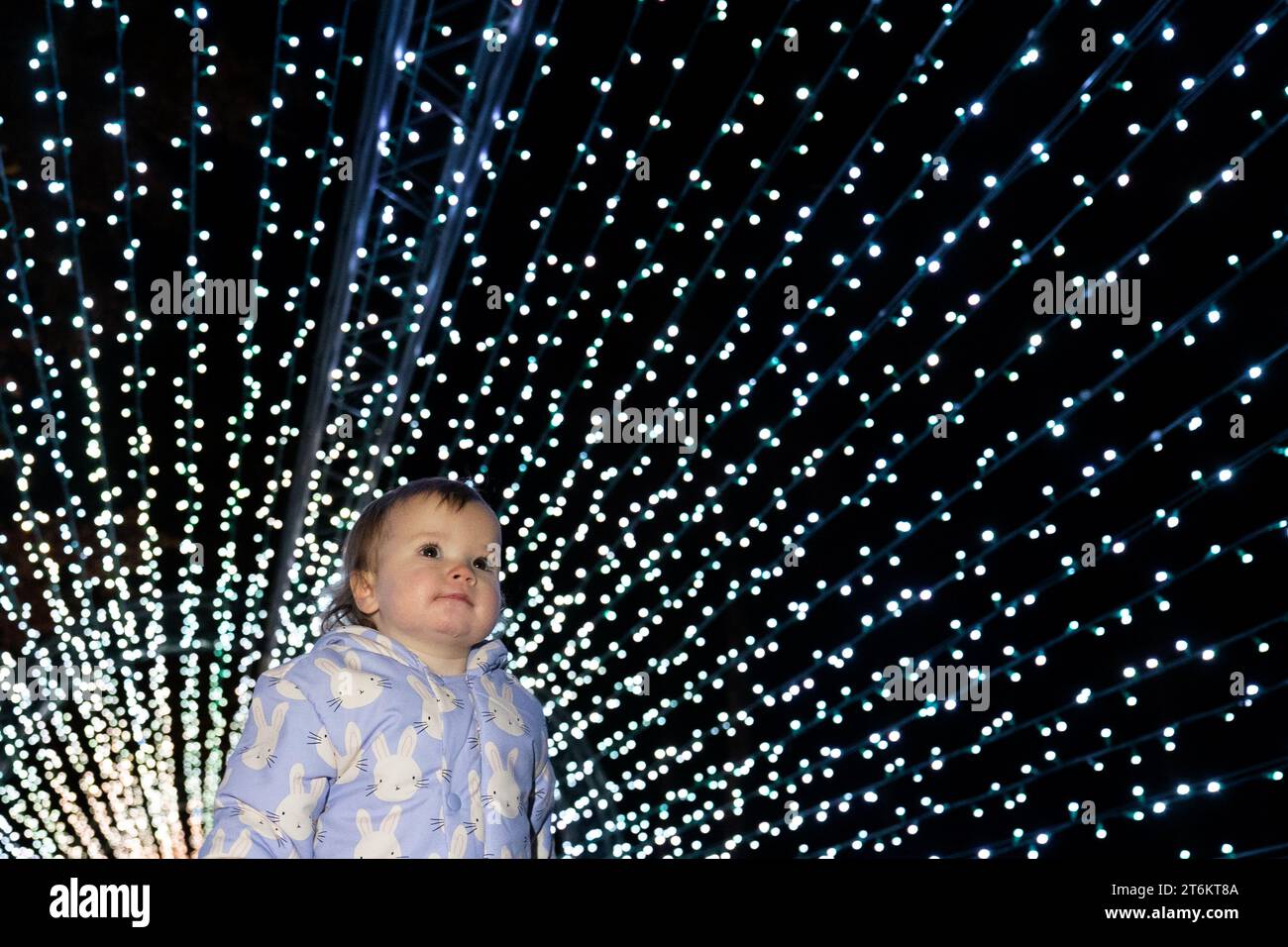 One-year-old Summer enjoys walking through a light installation during ...