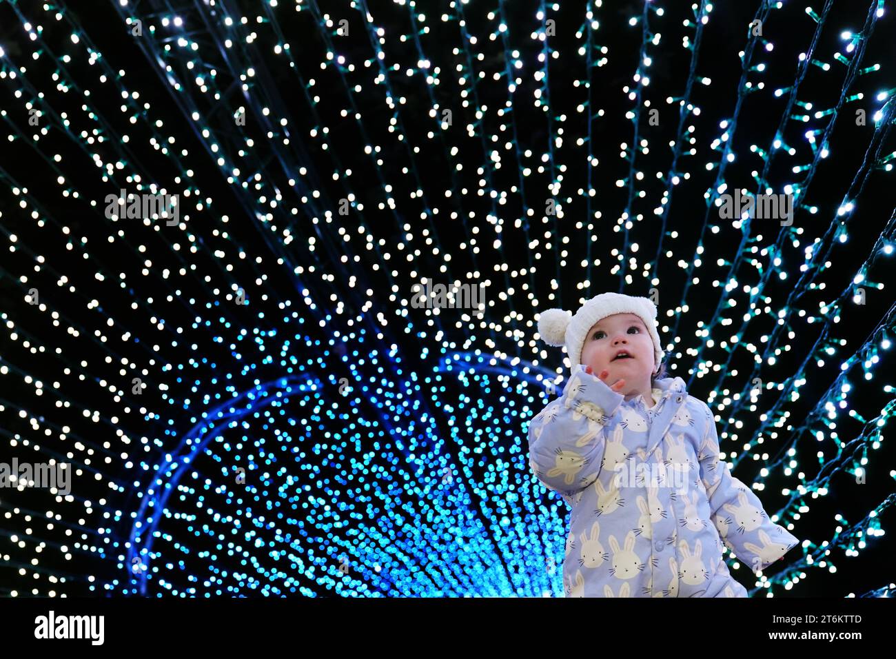 One-year-old Summer enjoys walking through a light installation during ...