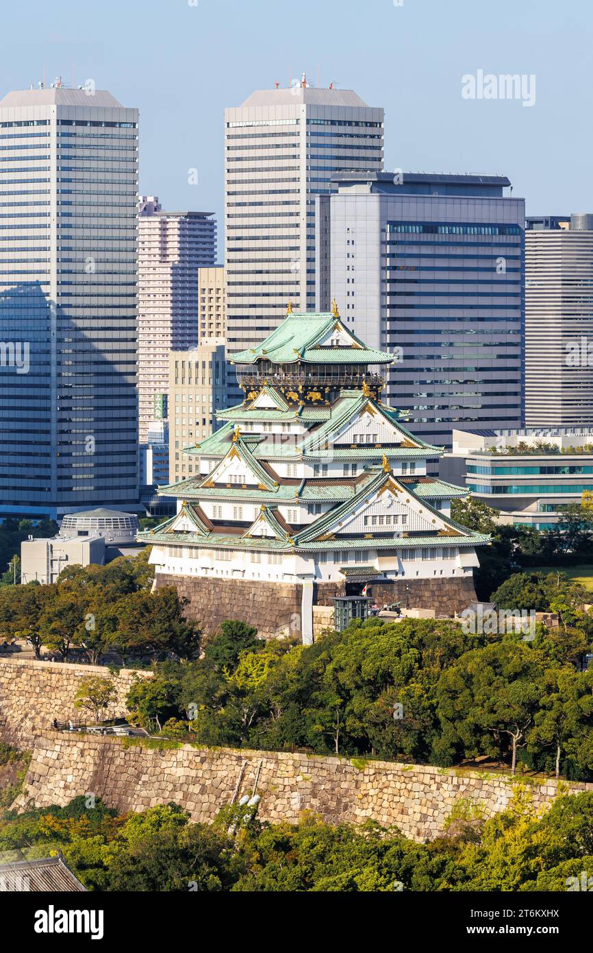 Osaka Castle from above skyline with skyscraper portrait format city in ...