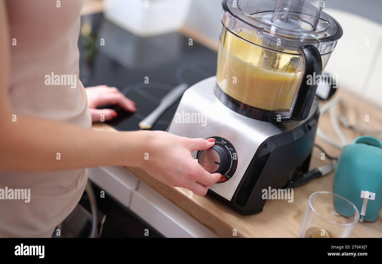 Woman adjusting speed of food processor closeup Stock Photo - Alamy
