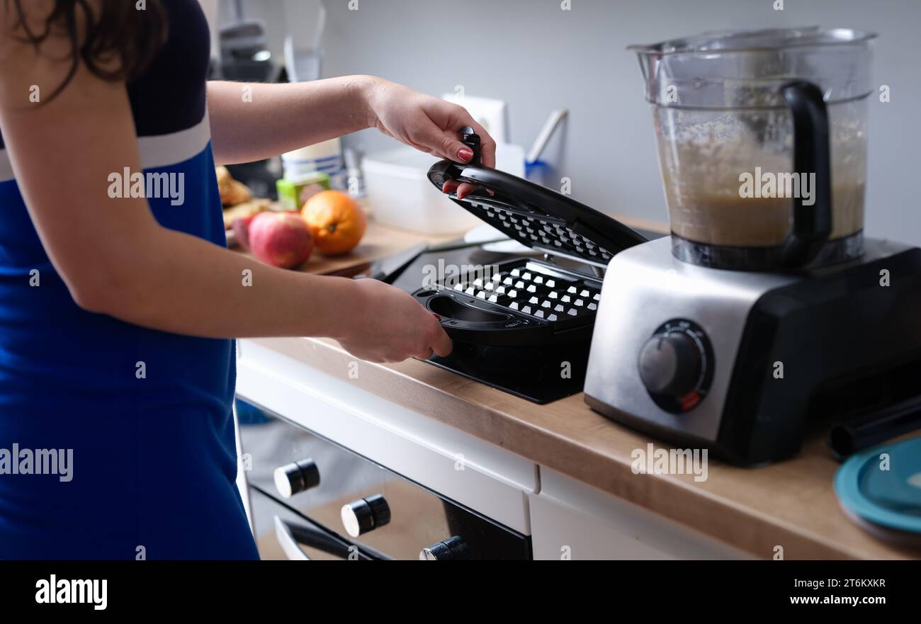 Woman opens electric waffle hi-res stock photography and images - Alamy