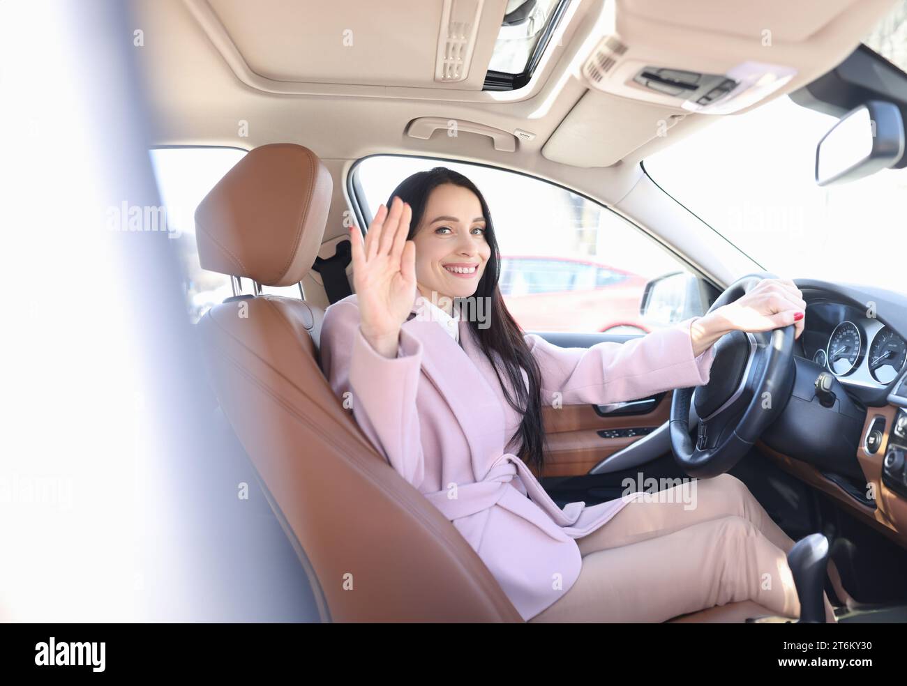 Woman waving in car hi-res stock photography and images - Alamy