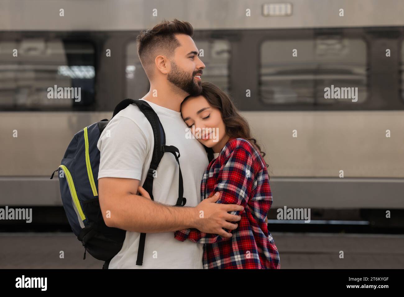 Long-distance relationship. Beautiful couple hugging on platform of ...