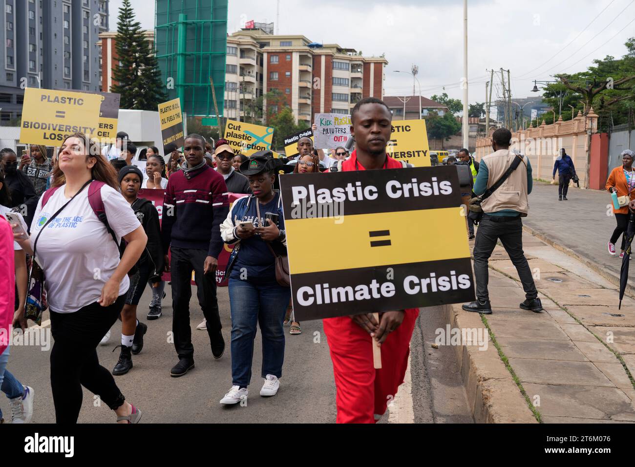 Climate activists carry banners and placards calling for a reduction in global plastic ...