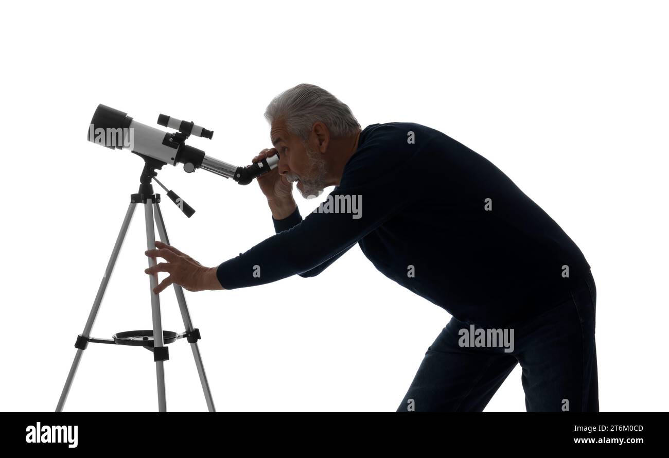 Senior astronomer looking at stars through telescope on white ...
